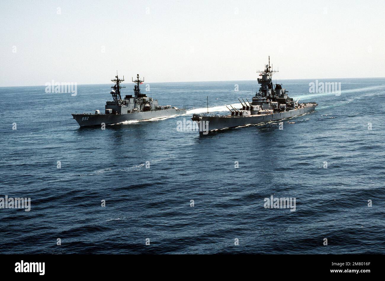 Aerial port bow view of the destroyer USS FLETCHER (DD-992) (left) and ...