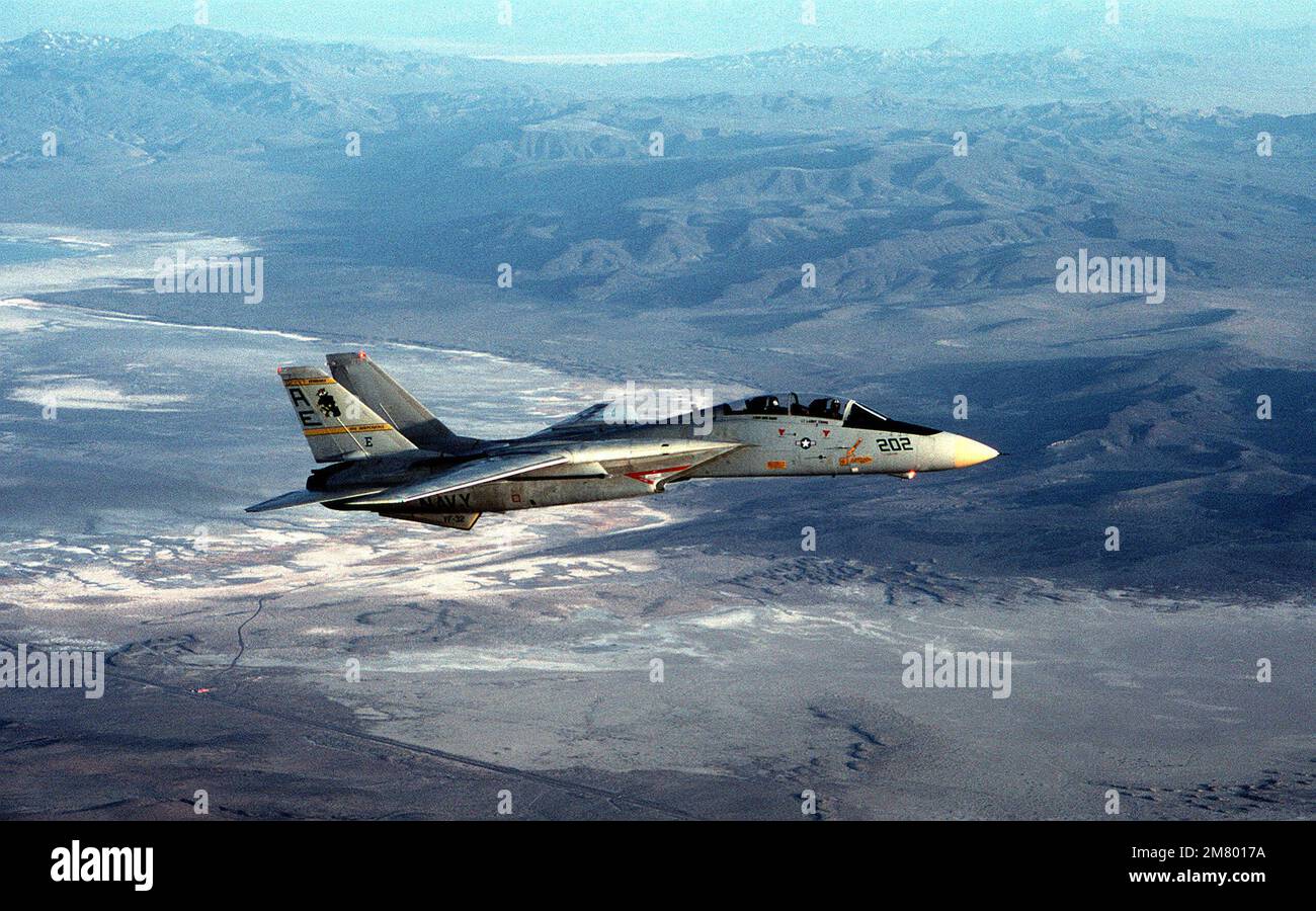 An air-to-air right side view of an F-14 Tomcat aircraft from Carrier ...
