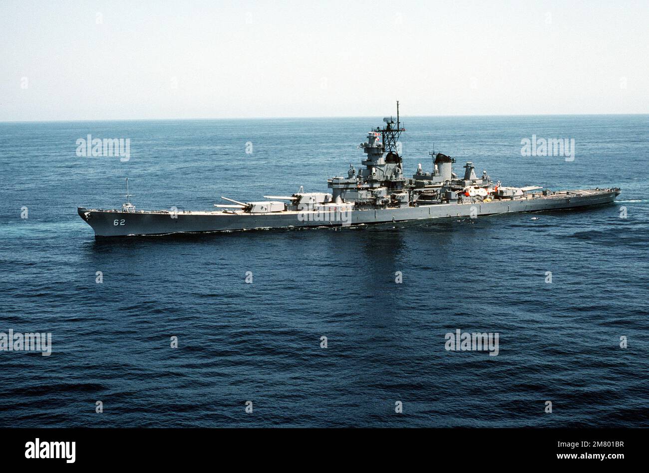 An aerial port view of the battleship USS NEW JERSEY (BB-62) underway ...