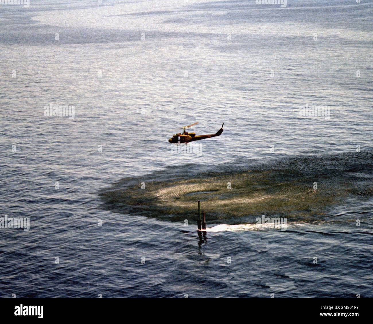 A UH-1 Iroquois helicopter flies over the nuclear-powered attack ...