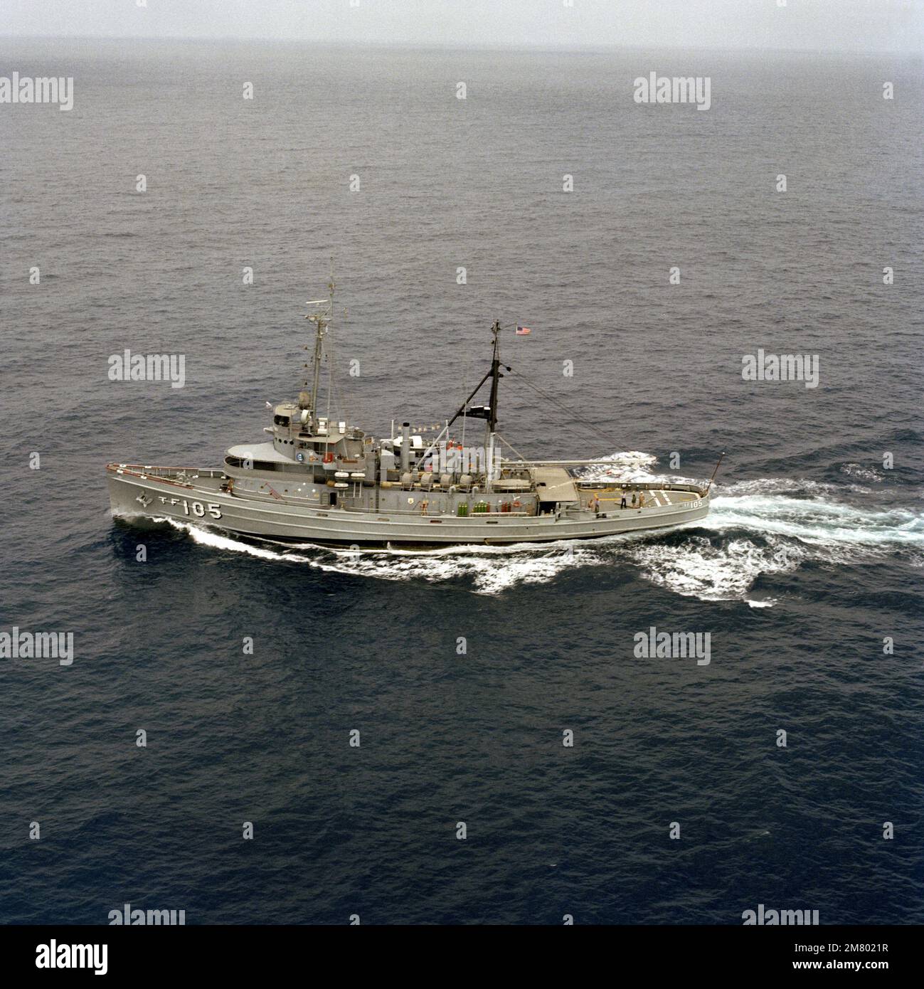 An aerial port beam view of the fleet tug USS MOCTOBI (ATF 105 ...