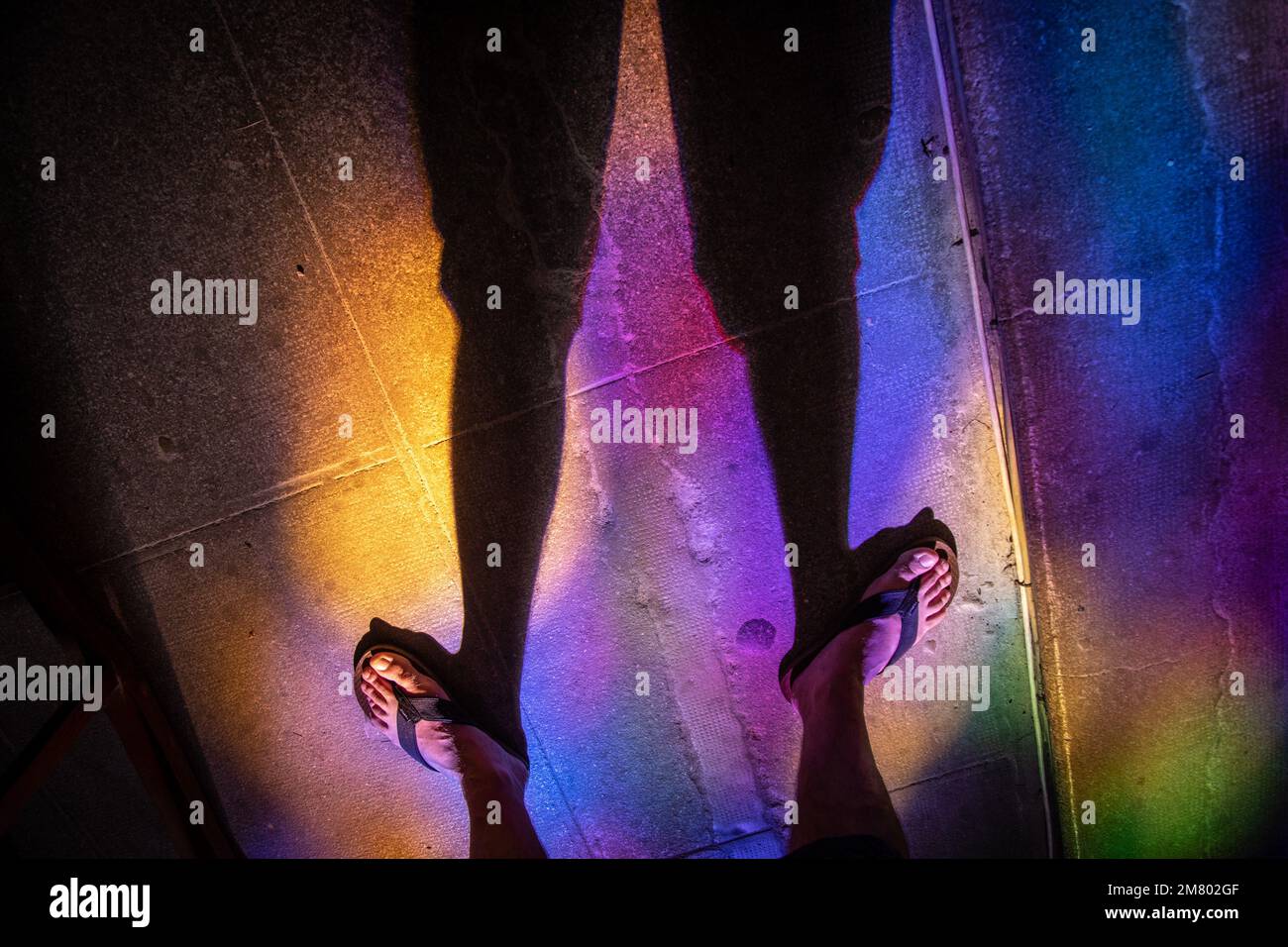 REFLECTIONS OF THE STAINED GLASS ON THE FLOOR AND FEET, SAINT-SAUVEUR ...