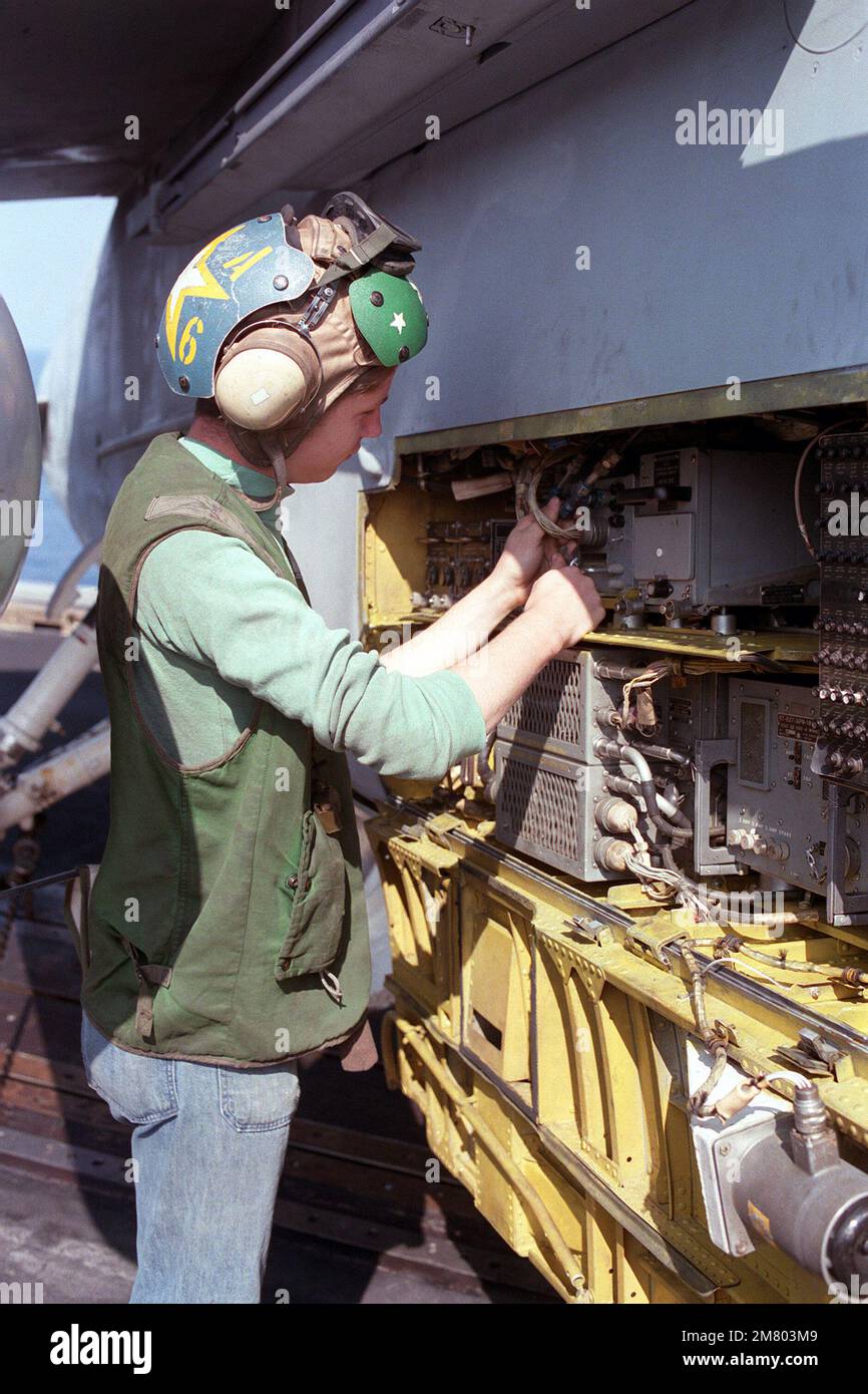 A maintenance crew member of Attack Squadron 66 (VA-66) conducts a ...