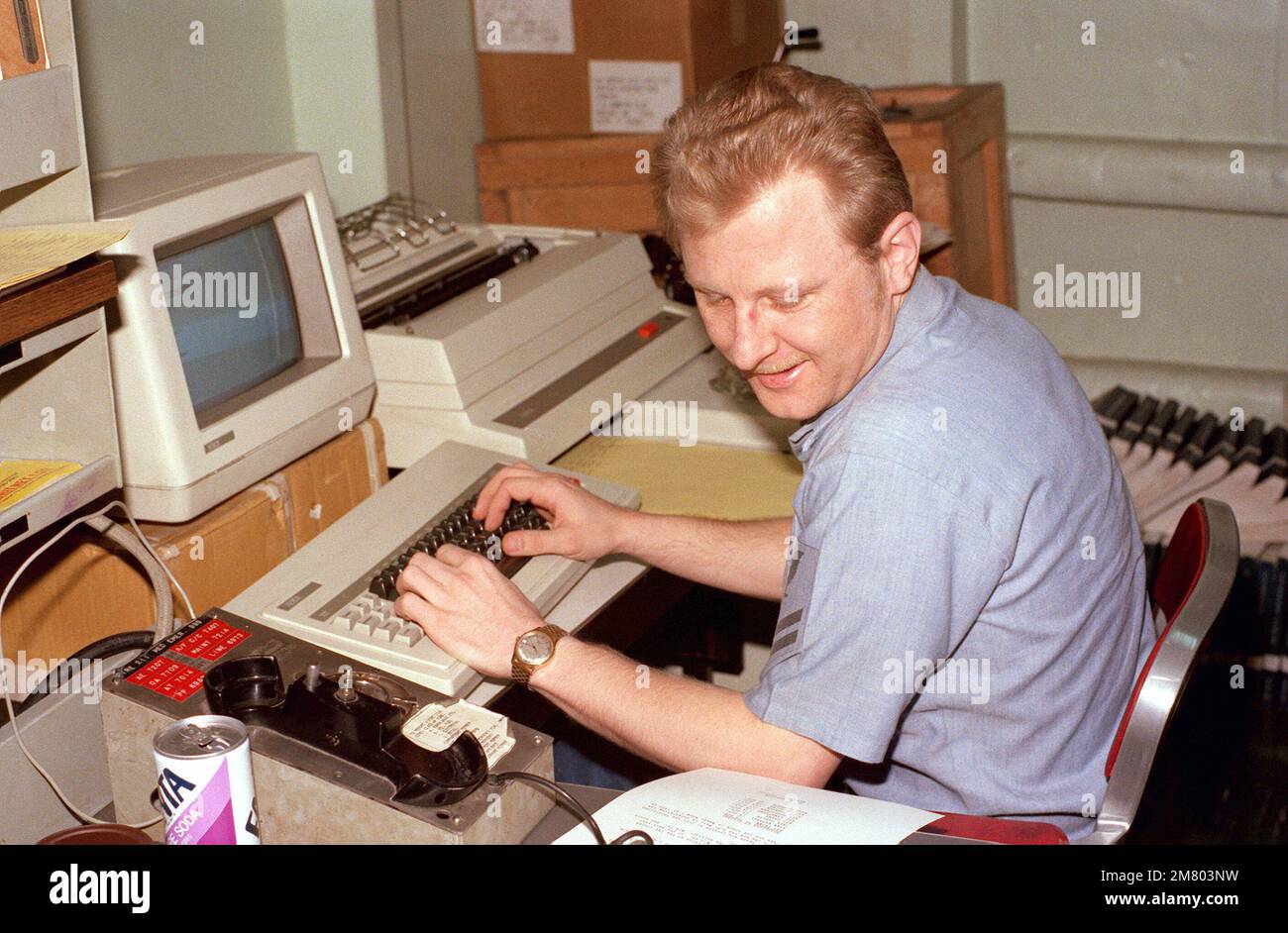 Yeoman 2nd Class R. Raschre works on a computer in the Tactical ...