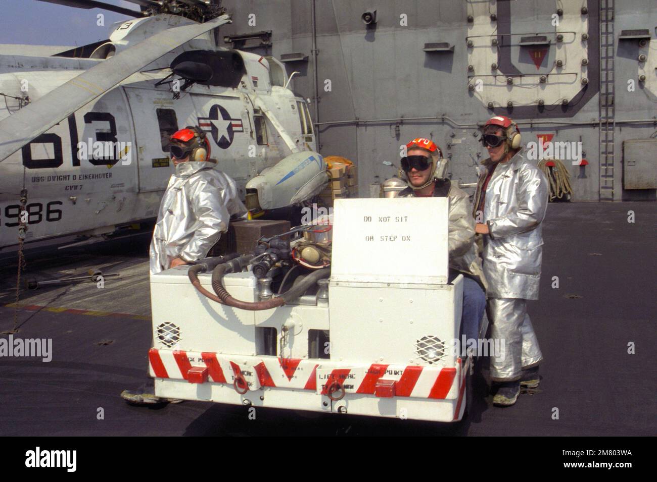 Flight deck firefighters stand by their P-16 shipboard firefighting and ...