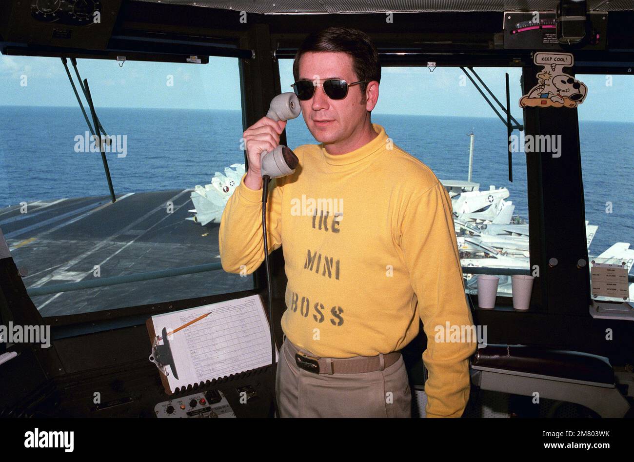 The assistant air operations officer talks on a telephone in Pri-Fly ...