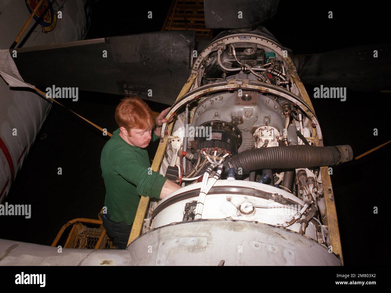 A member of Airborne Early Warning Squadron 121 (VAW-121) works on an ...