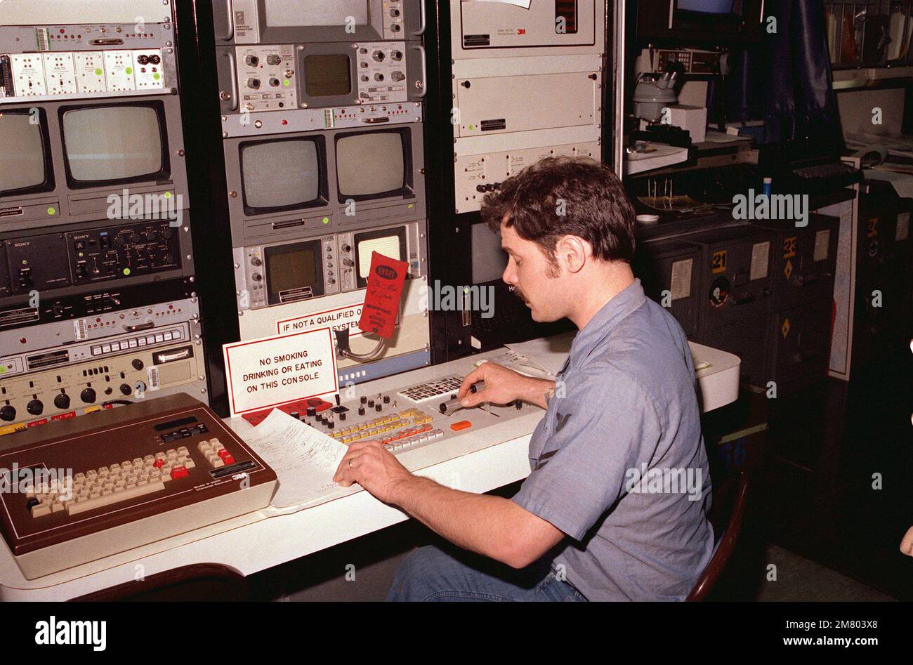 A sailor operates an intelligence console aboard the nuclear-powered ...