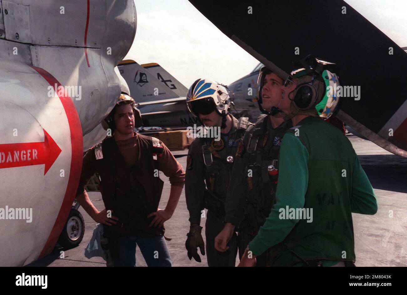 Pilot, co-pilot and flight deck personnel do a pre-flight check of an ...