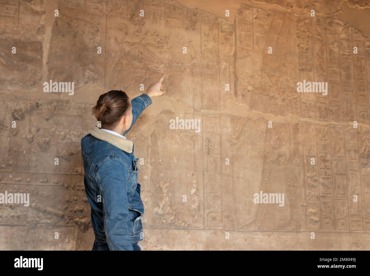 Unrecognizable tourist young man pointing and admiring the ancient and ...