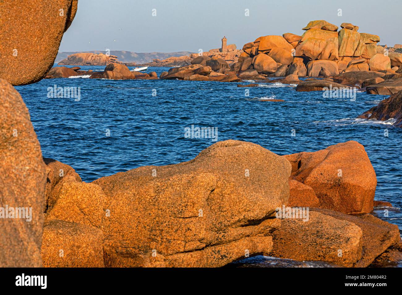 VIEW FROM THE PINK GRANITE BOULDERS OF THE PLOUMANACH LIGHTHOUSE AT SUNSET, RENOTE ISLAND POINT ...