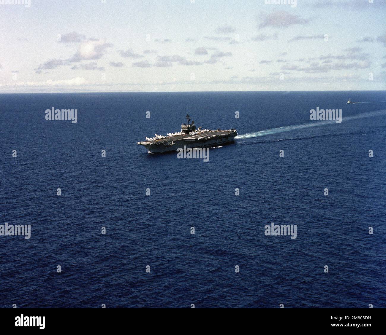 An aerial port bow view of the aircraft carrier USS KITTY HAWK (CV 63 ...