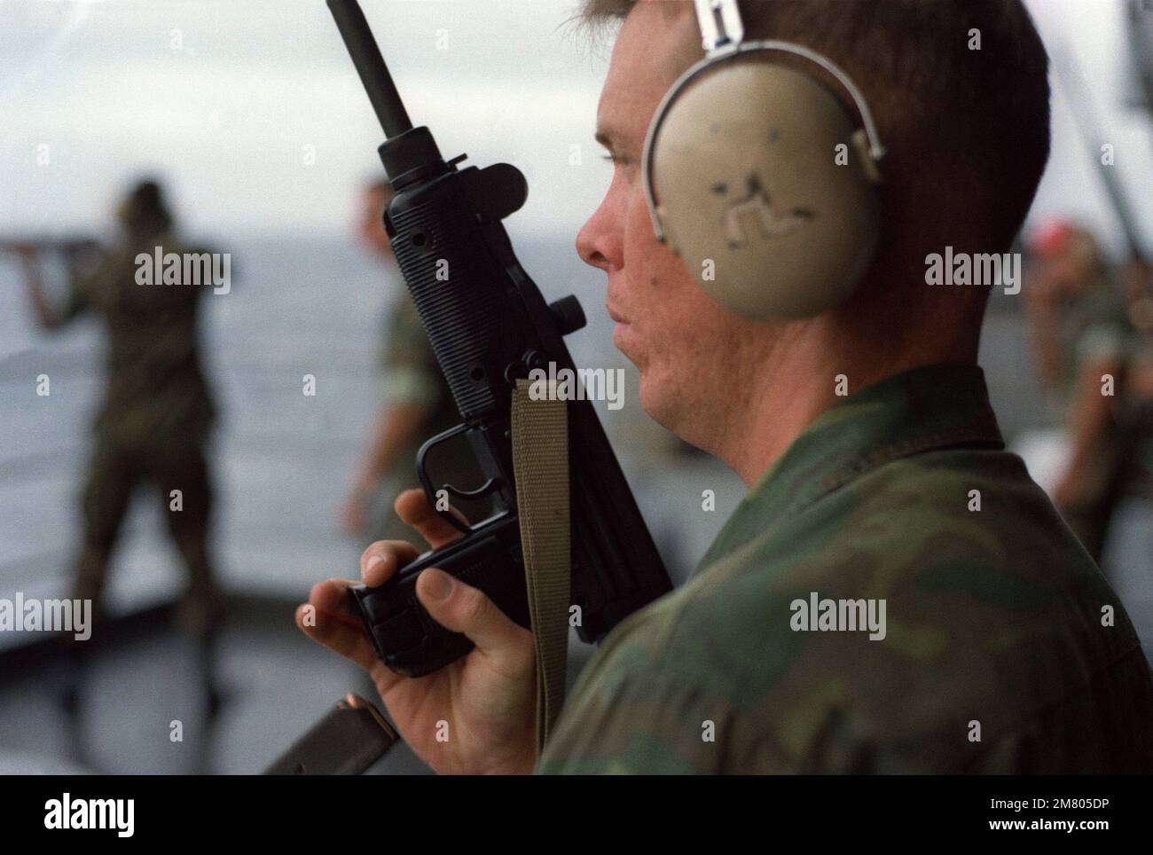 A Marine holds an Uzi 9 mm submarine gun during a familiarization ...