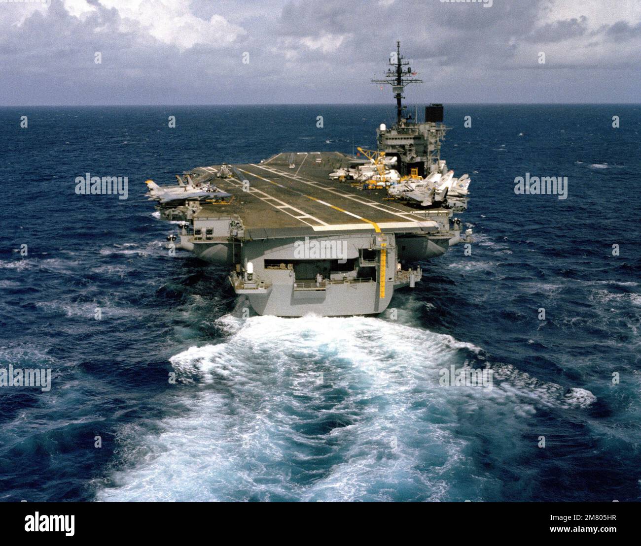An aerial stern view of the aircraft carrier USS KITTY HAWK (CV 63 ...