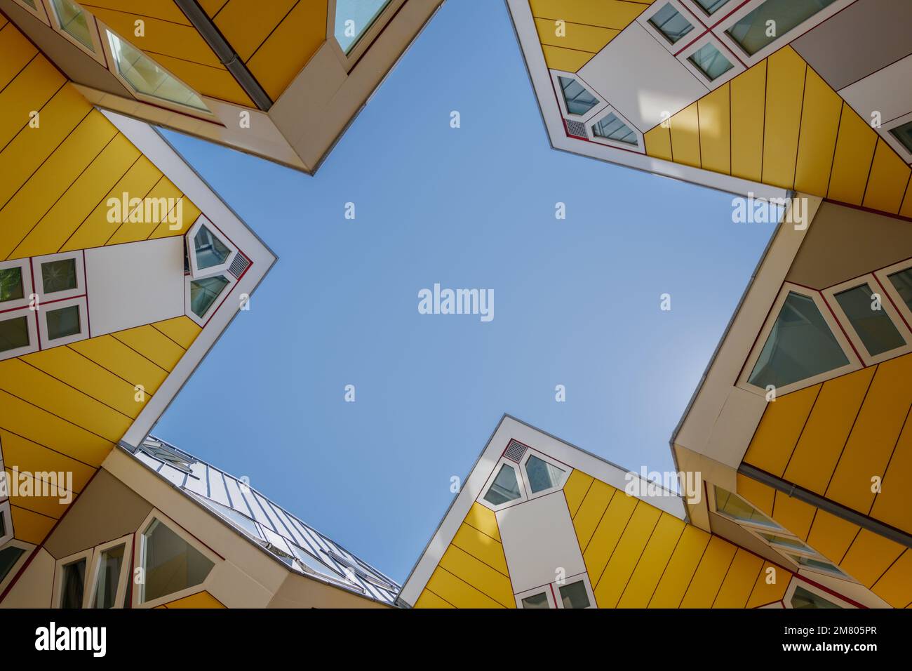 Low angle view at courtyard between group of yellow cube residential ...