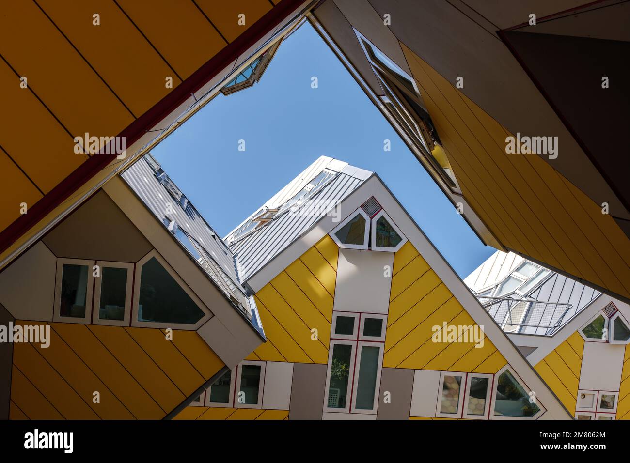 Low angle view at courtyard between group of yellow cube residential ...