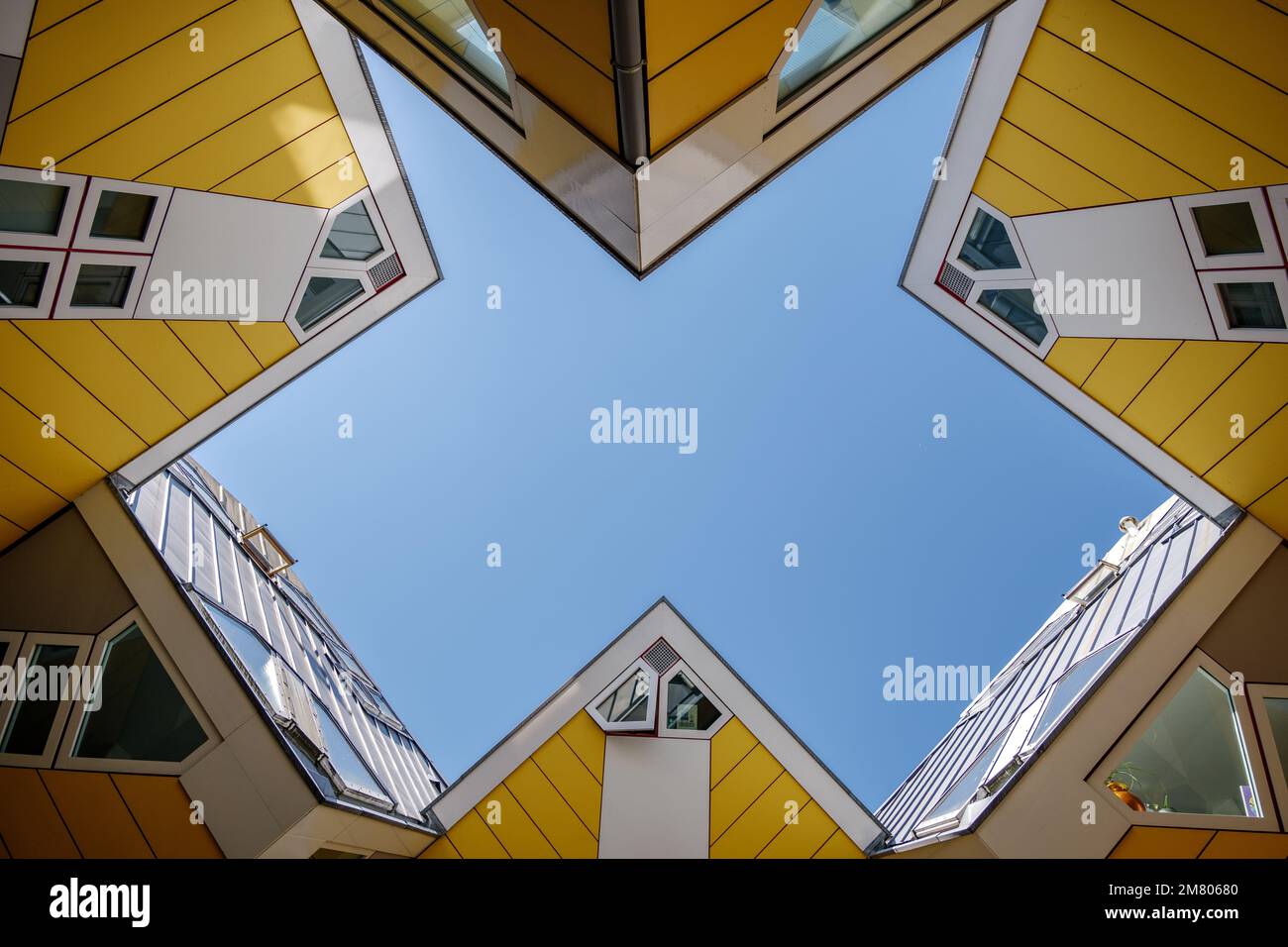 Low angle view at courtyard between group of yellow cube residential ...