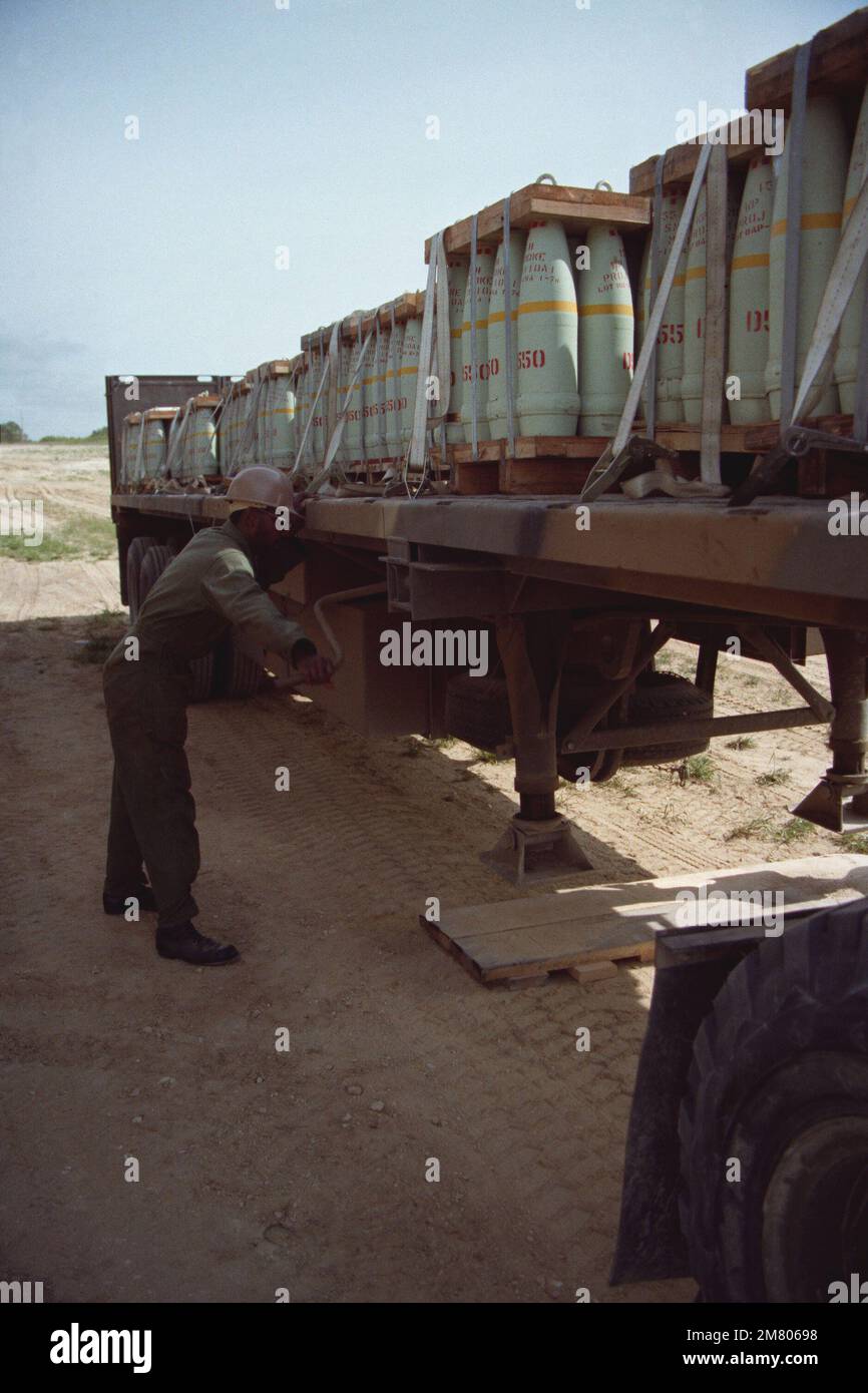 The supports are lowered on a flatbed truck for the unloading of shells ...