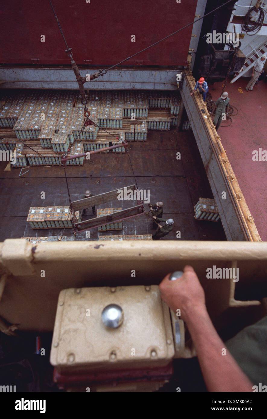 A winch is used to offload pallets of ammunition from the cargo area of ...
