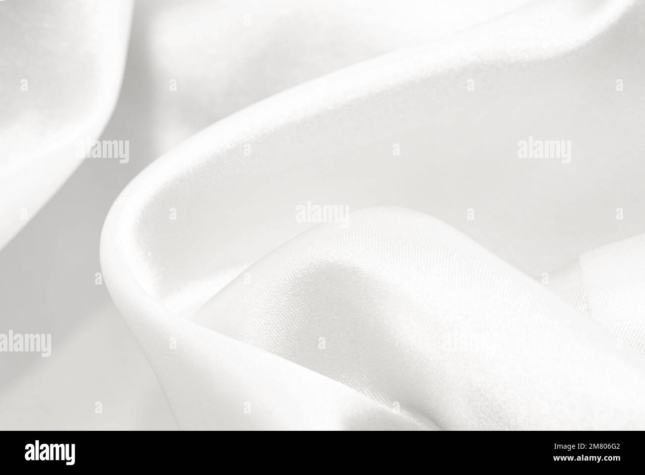 The texture of a fabric made of silk or calico with waves and rumples ...