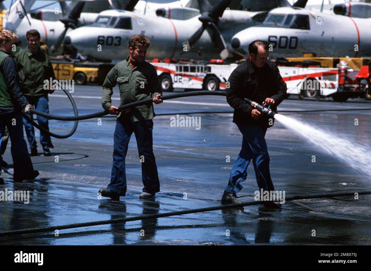 Crewmen hose down flight hi-res stock photography and images - Alamy