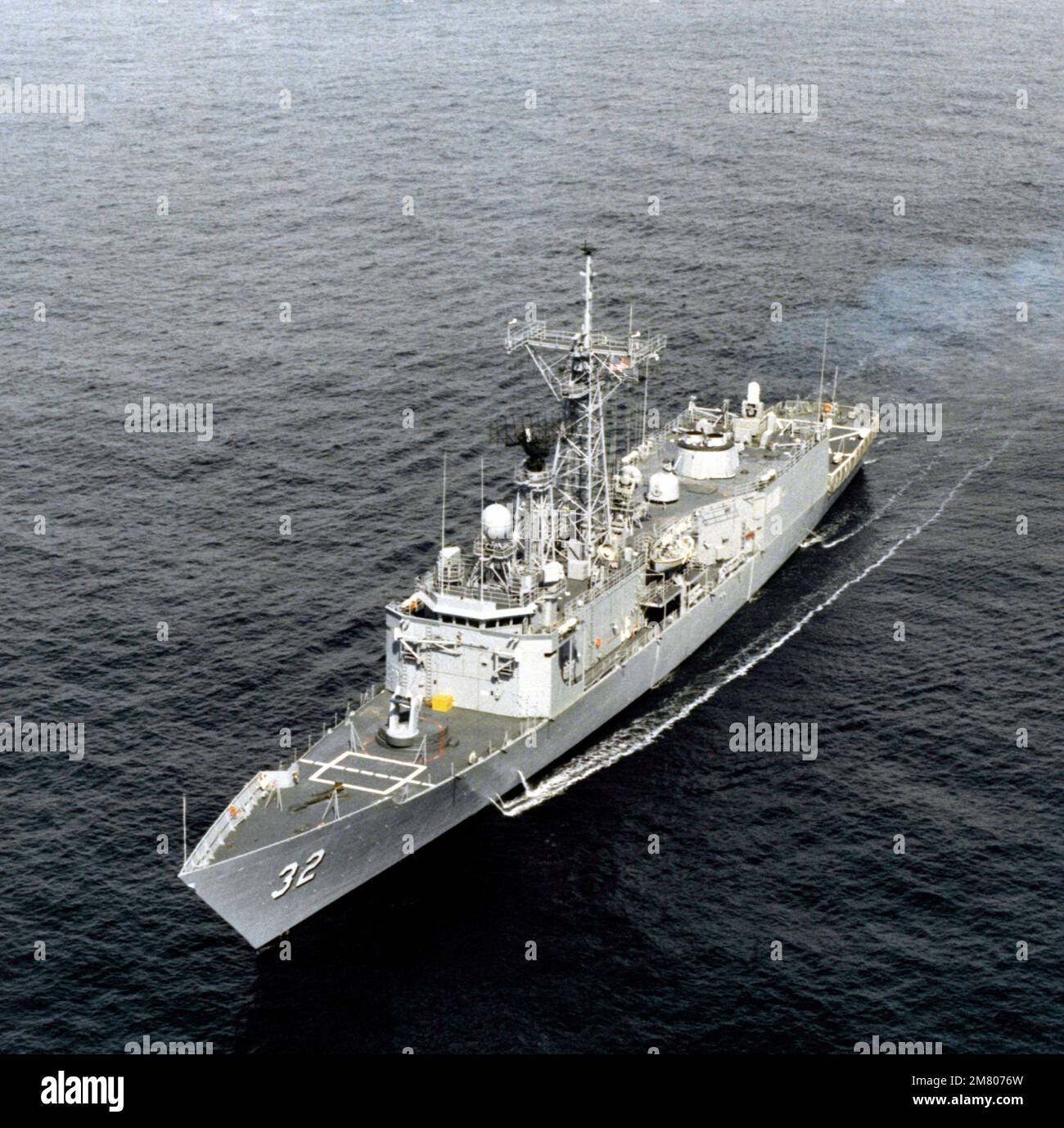 An aerial port bow view of the guided missile frigate USS JOHN L. HALL ...