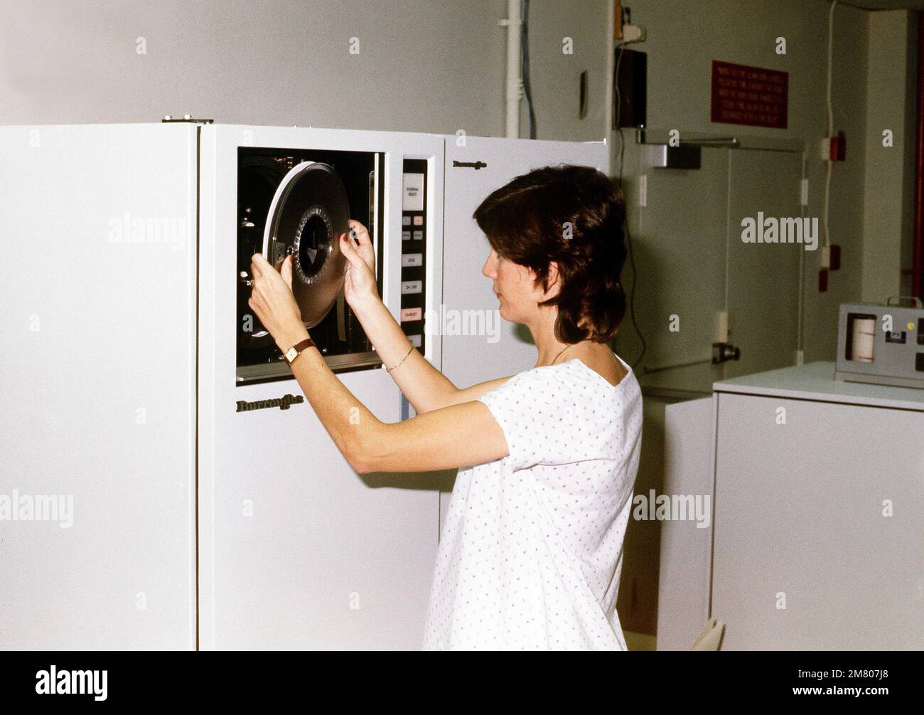 A technician changes the tape on a data processing machine at Gorgas ...