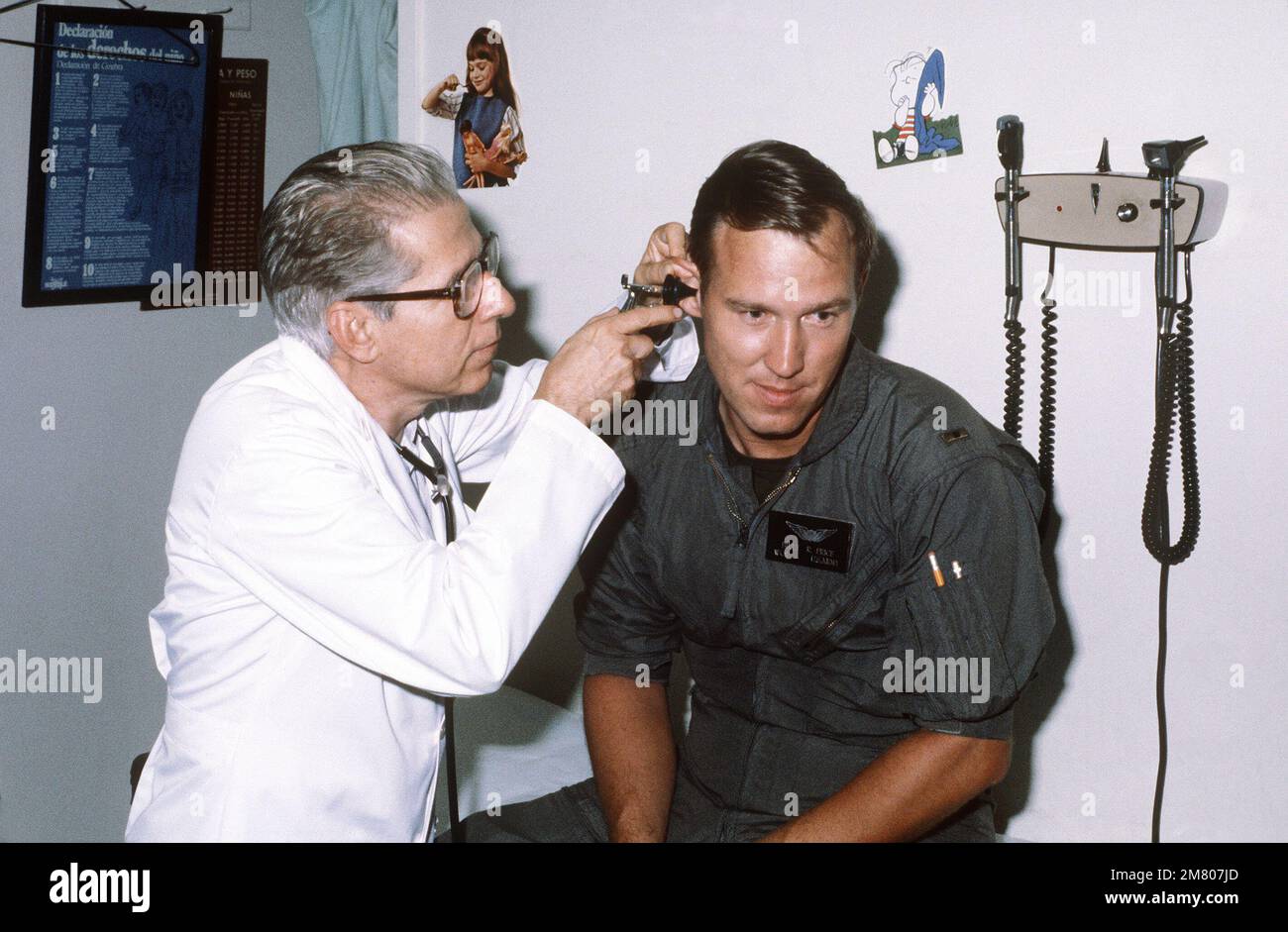 Dr. Real performs an ear examination at the US Army Health Clinic. Base ...
