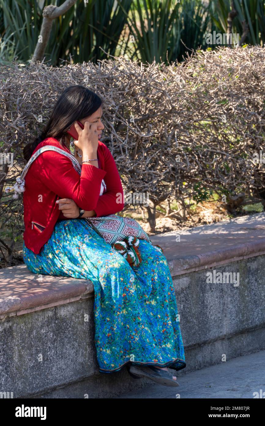 woman talking on the phone with traditional costume of the wixarika ...