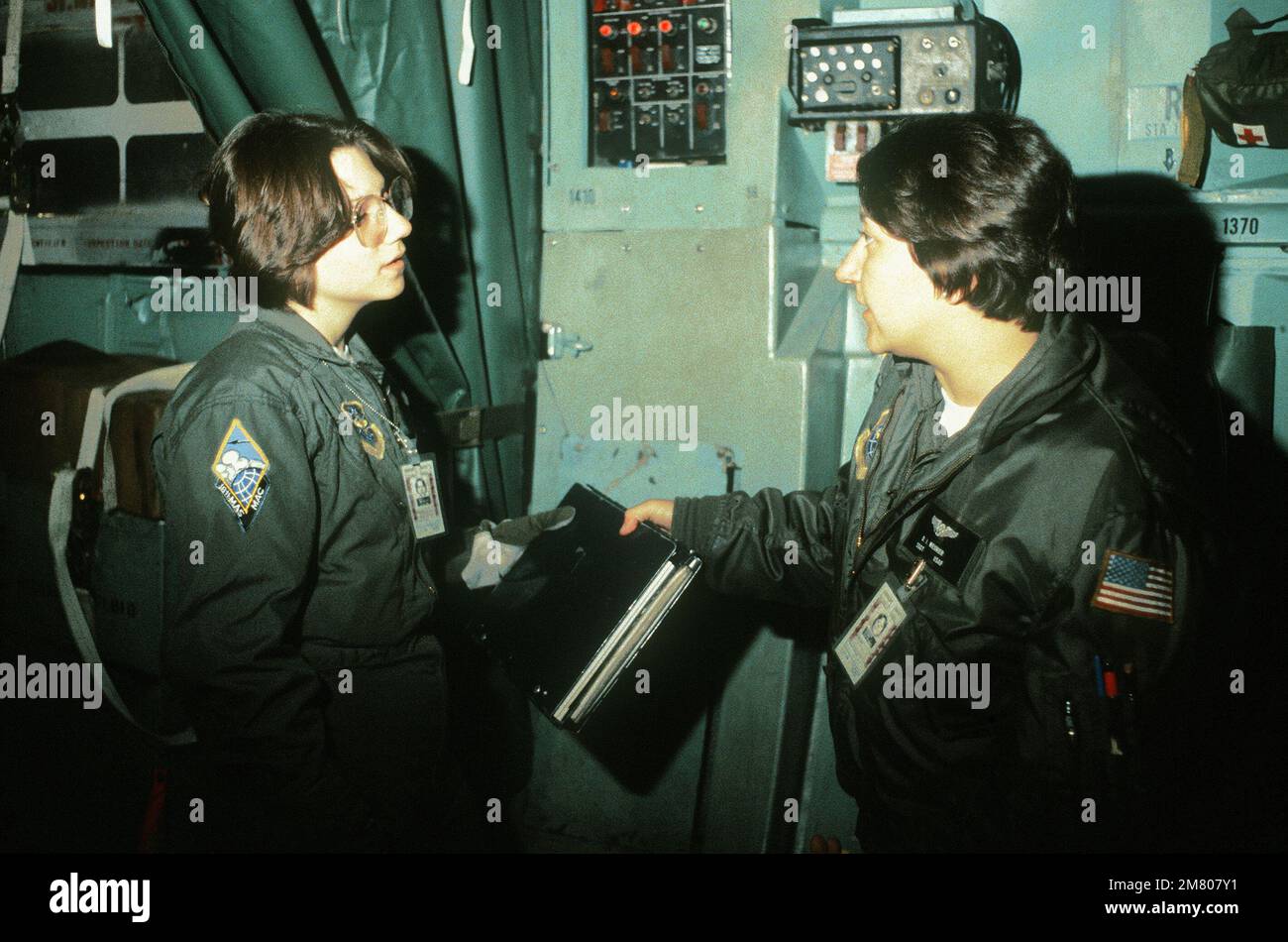 SSGT Denise Meunier, flight engineer, gives last minute instructions to ...