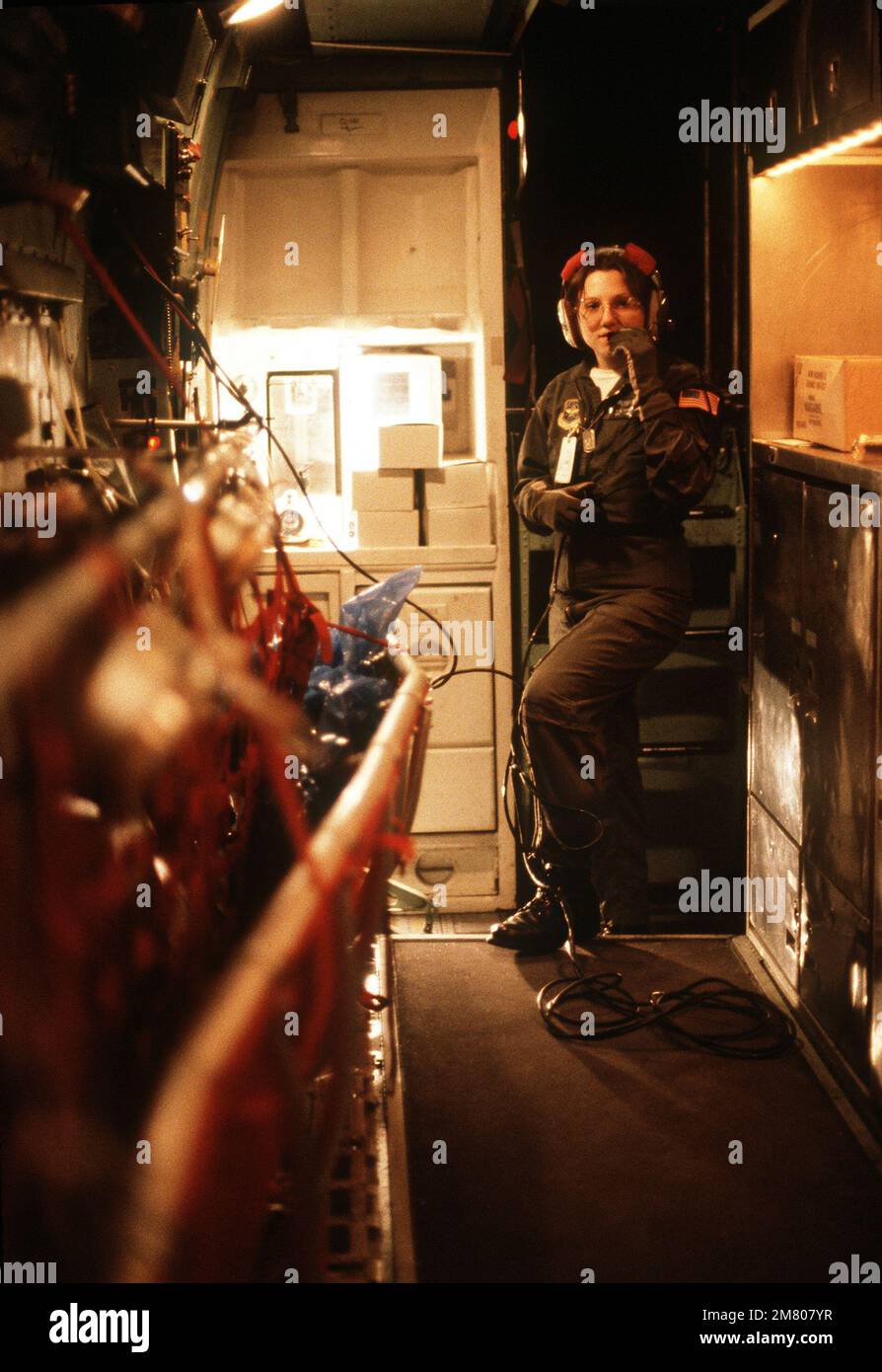 A1C Bernadette Botti performs her load master duties while in flight ...