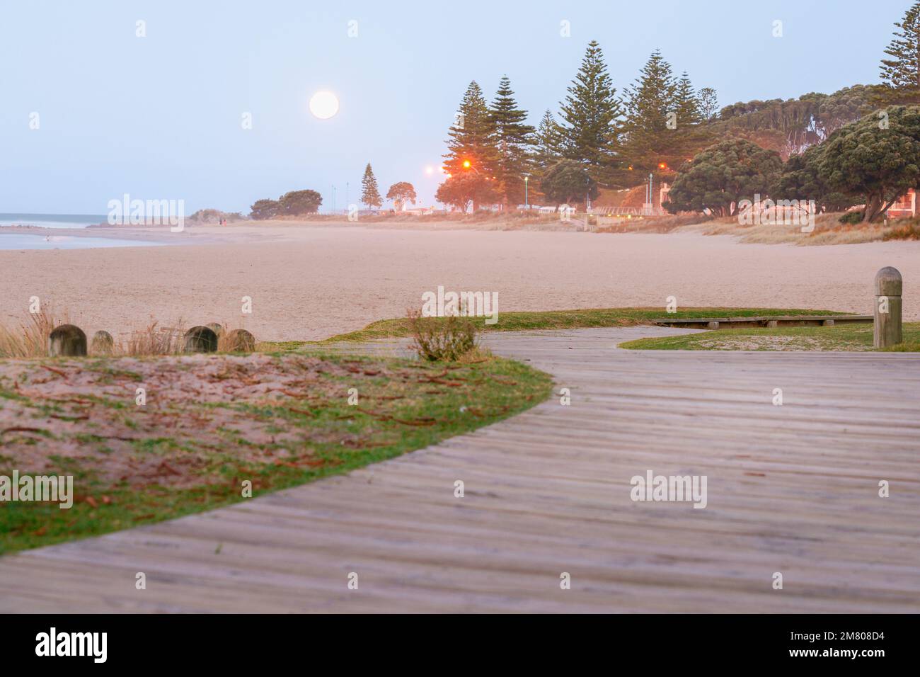 Golden rising moon over Mount Maunganui Main Beach in Tauranga New ...