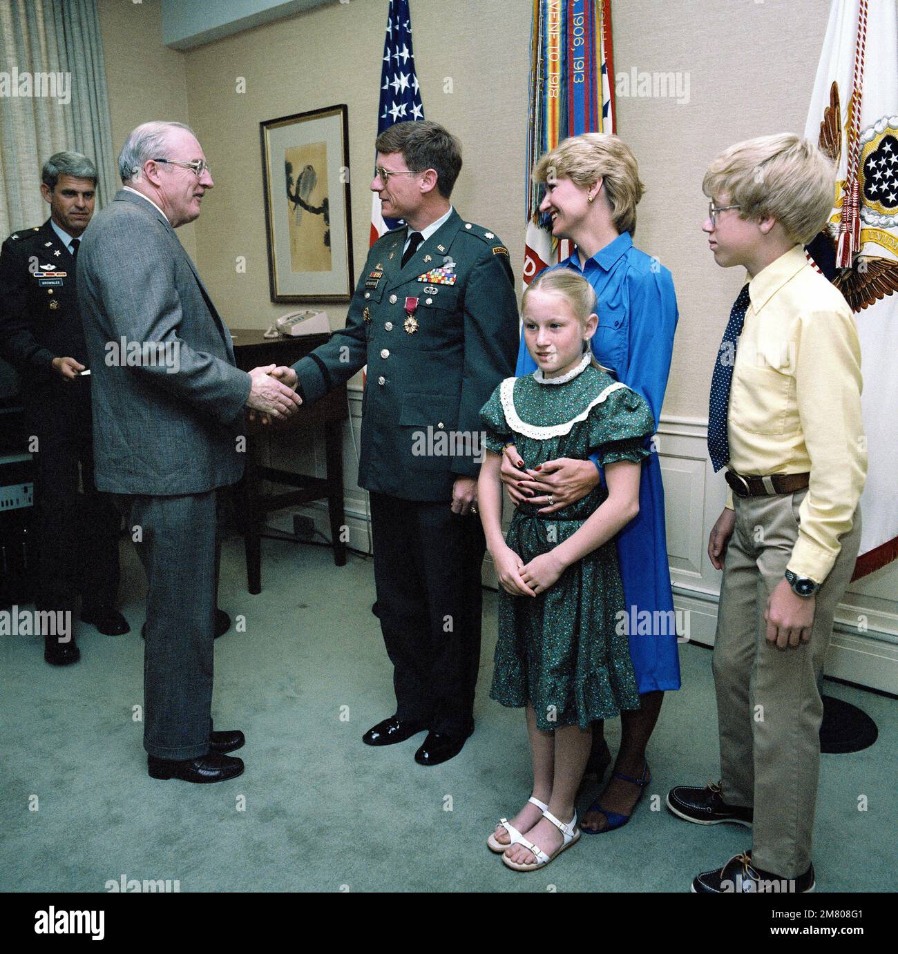 Undersecretary of the Army James R. Ambrose presents the Legion of ...