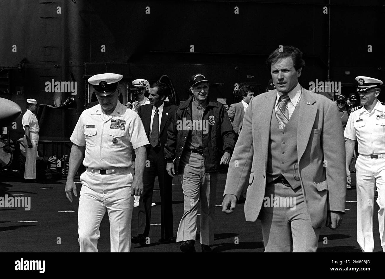 Vice President George Bush and several ship's officers walk onto the ...