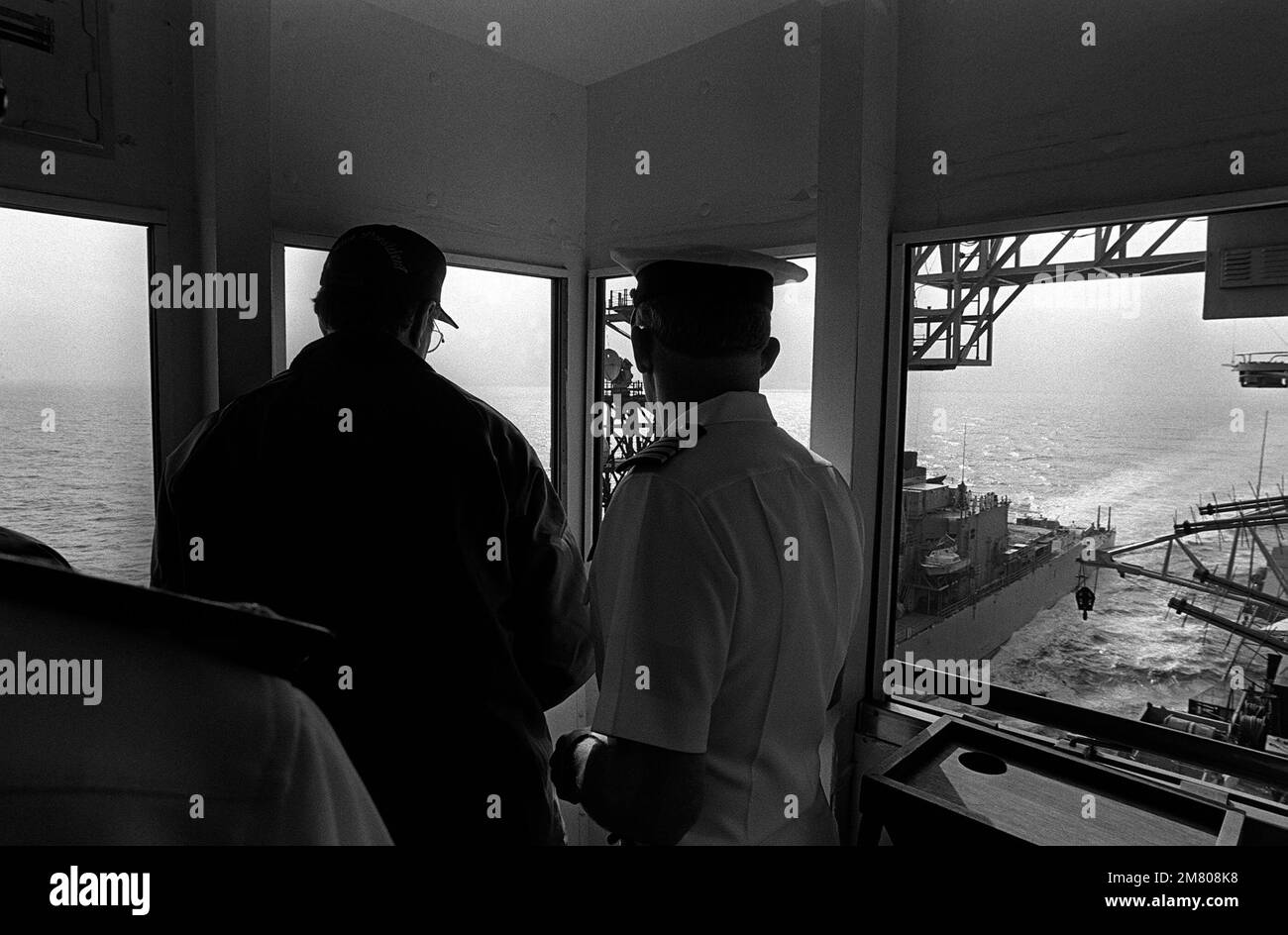 Vice President George Bush and CAPT Tony Less watch from the bridge of ...