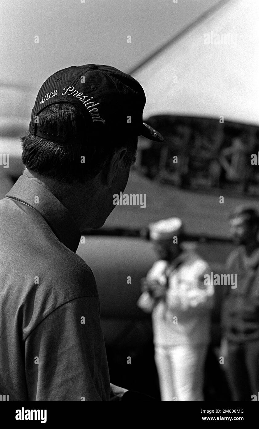 Vice President George Bush (back to camera) is greeted by the crew as ...