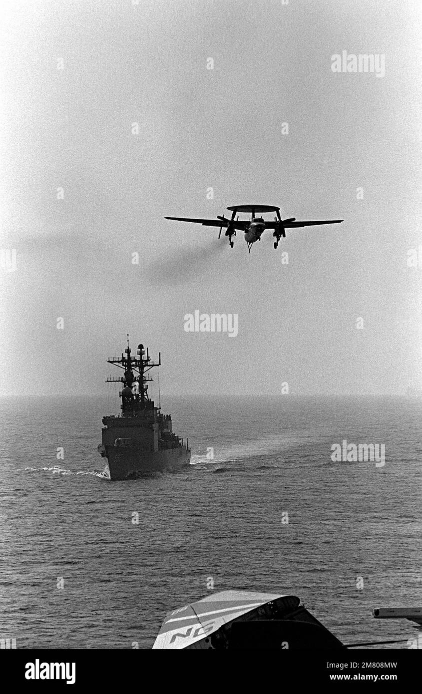 An E-2C Hawkeye airborne early warning aircraft makes a final approach ...