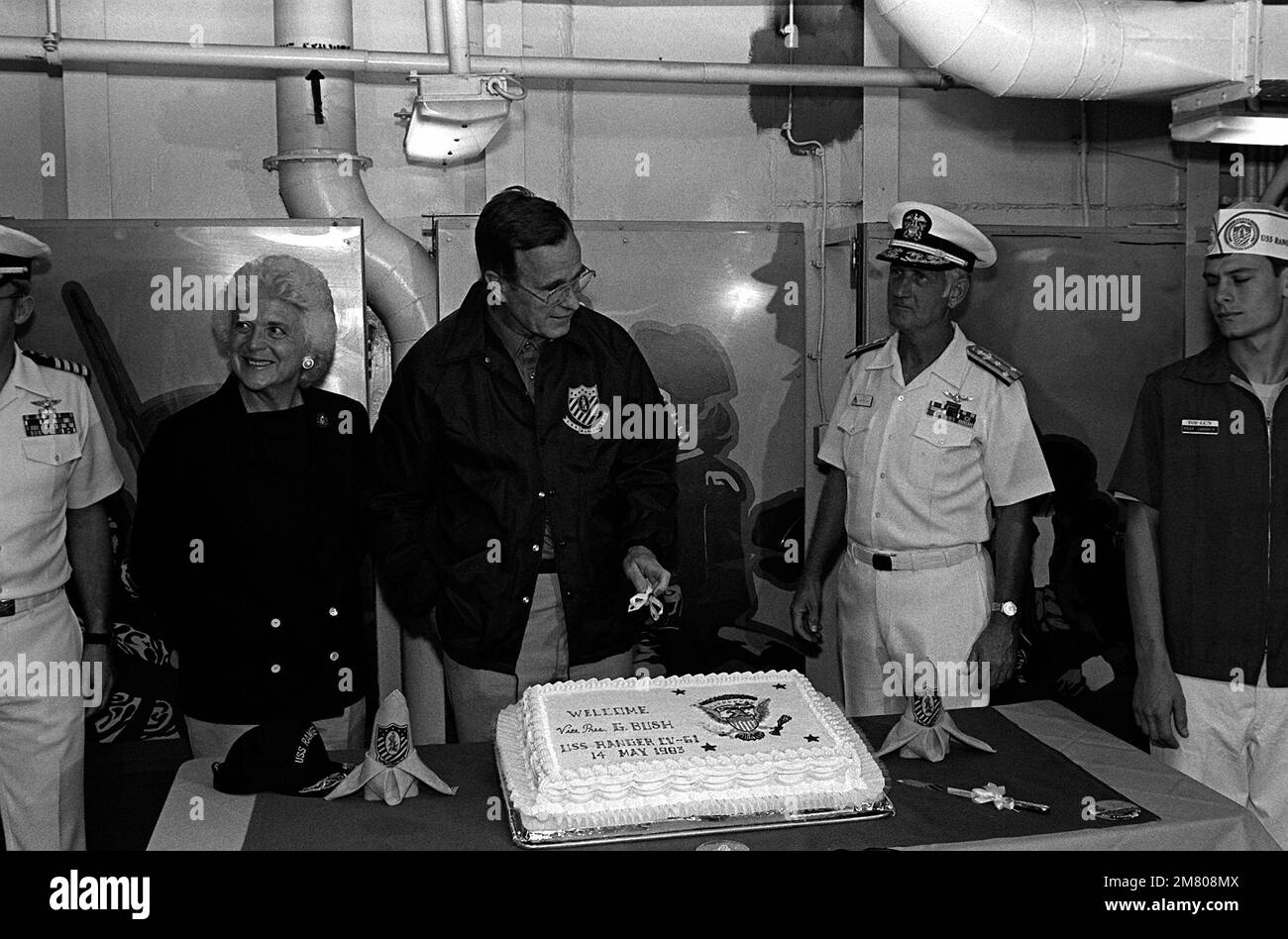 Vice President George Bush cuts a cake baked in honor of his visit to ...