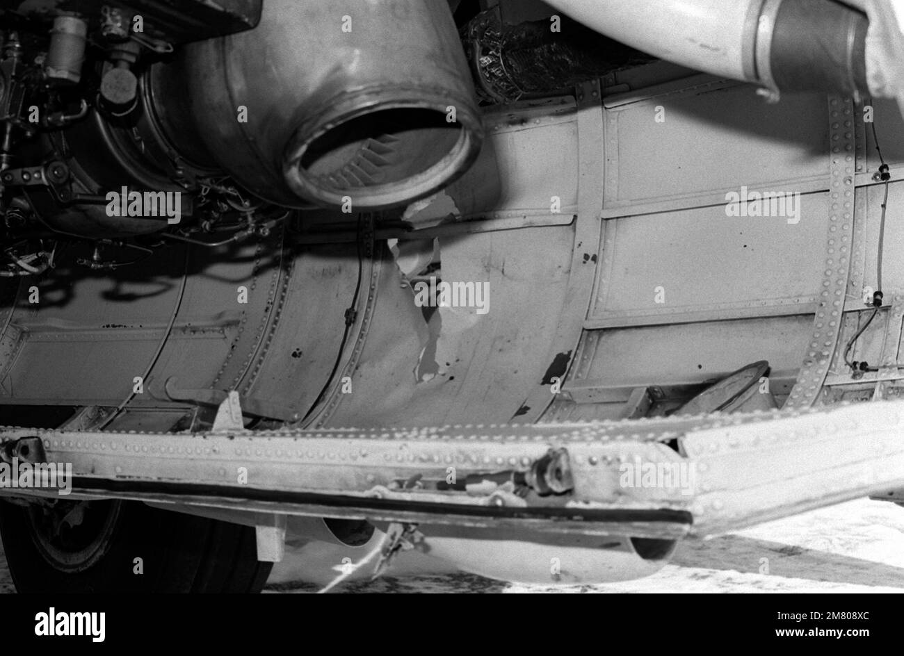 A interior view of damage to the port engine access door of an A-6E ...