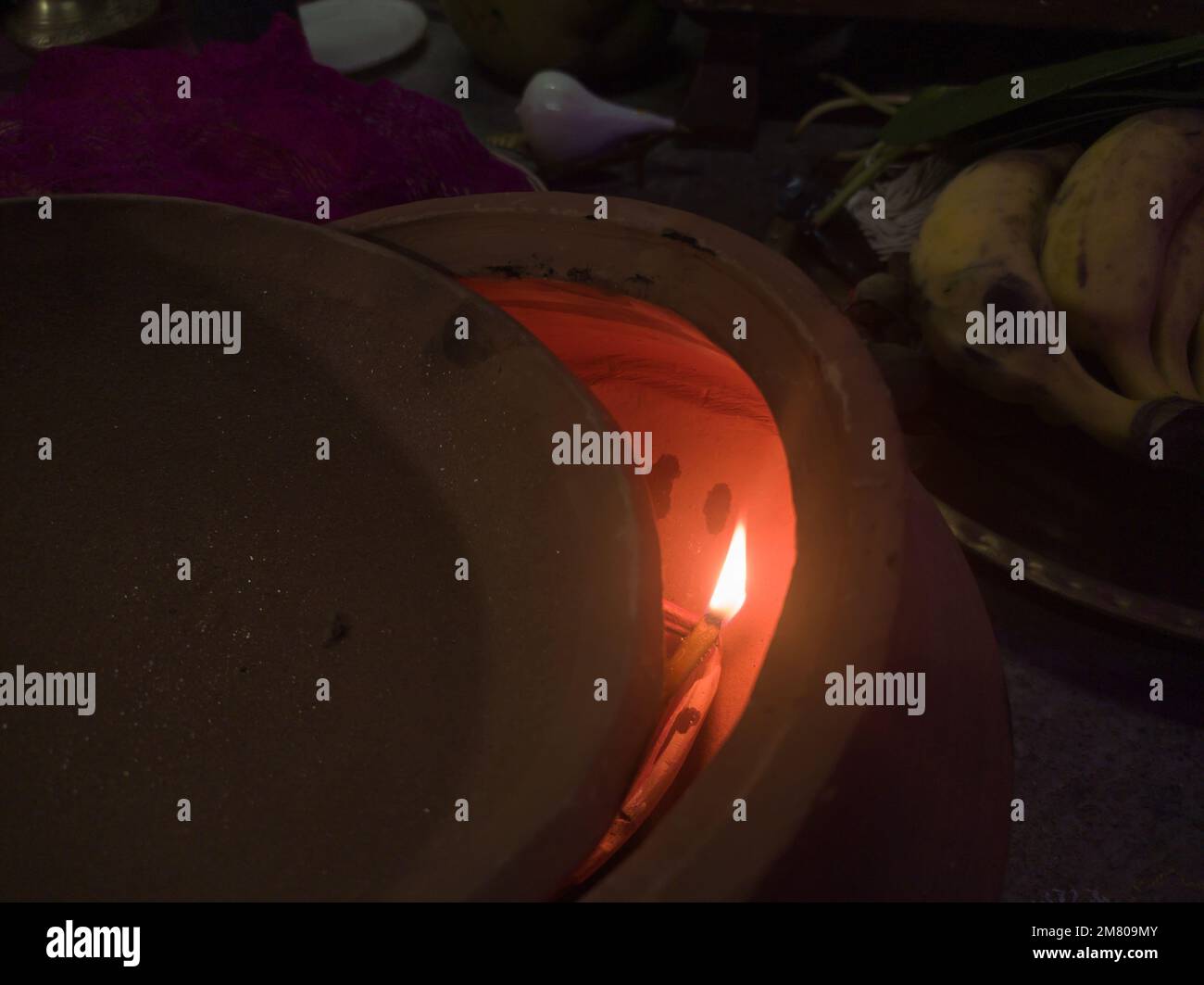 ritual of saraswati puja with oil lamp made of clay burning inside ...