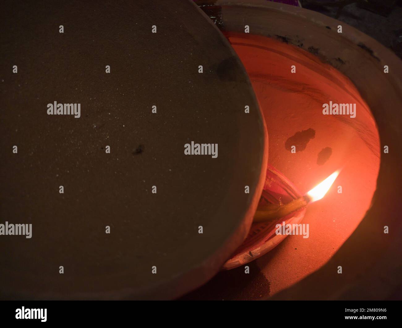 ritual of saraswati puja with oil lamp made of clay burning inside ...