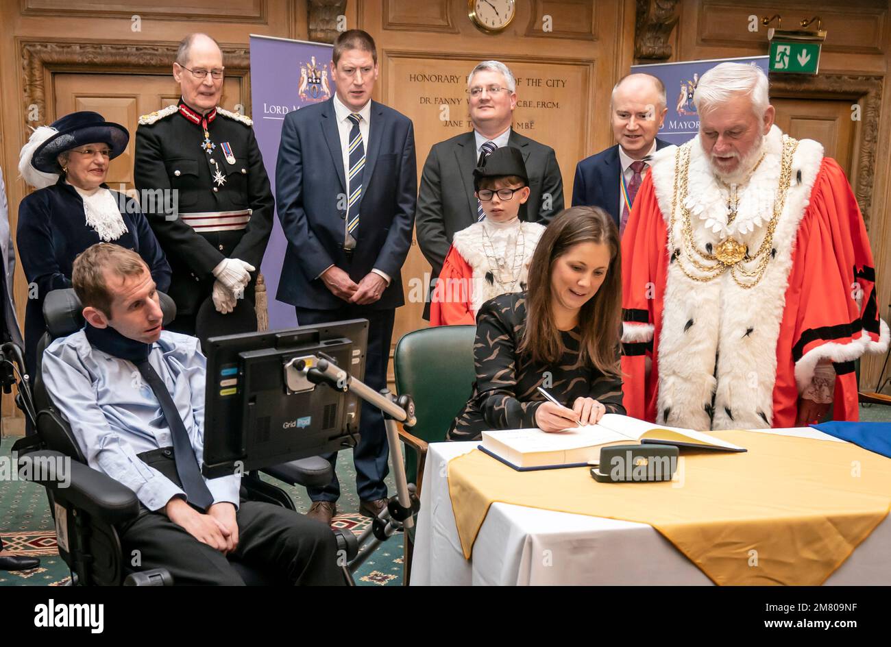 Lindsey Burrow signs the Scroll of Admission on behalf of her husband ...