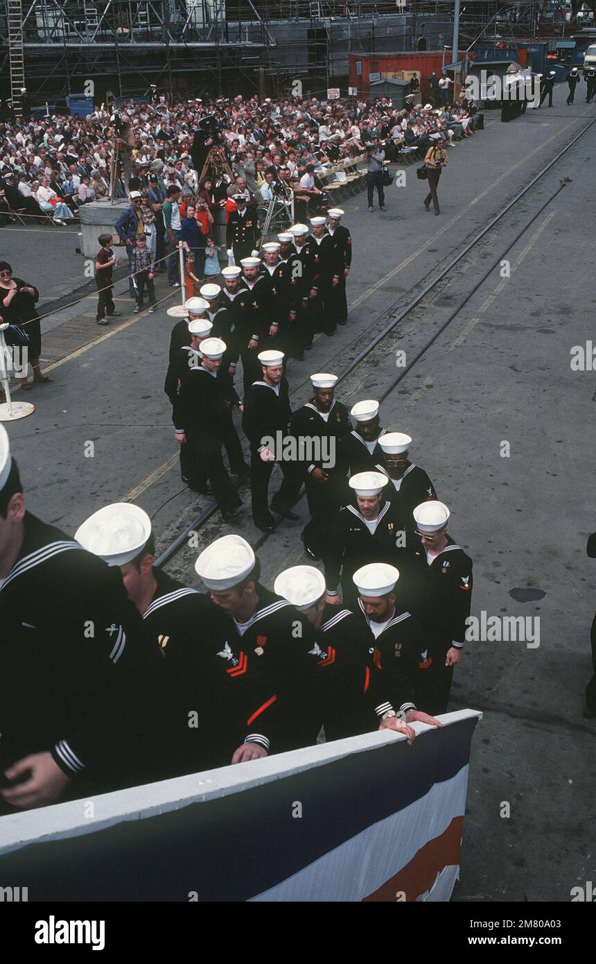 Crew members of the guided missile frigate USS DOYLE (FFG 39) man the ...