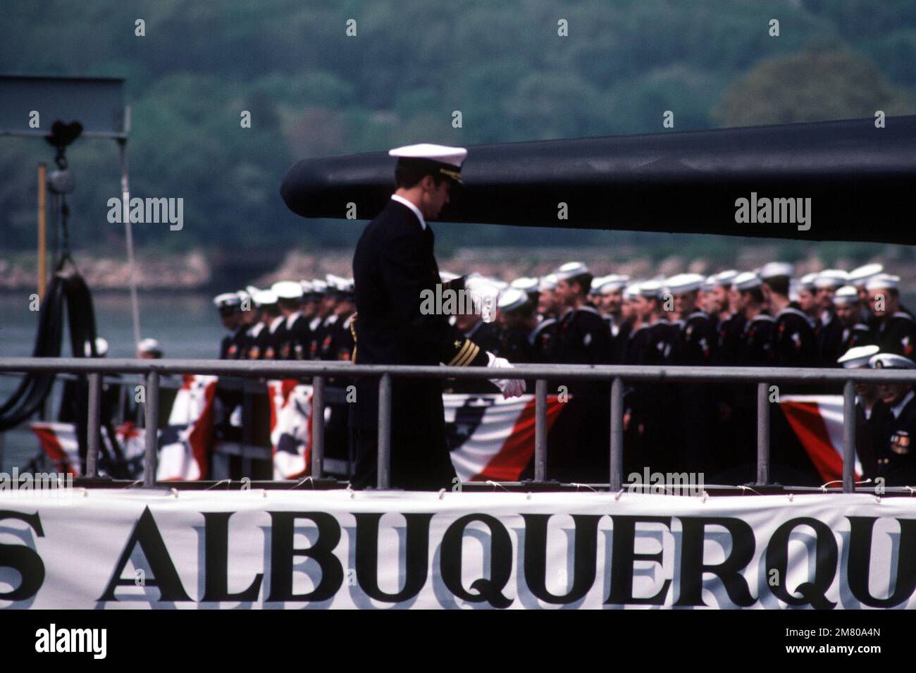 Crew members stand in formation aboard the nuclear-powered attack ...