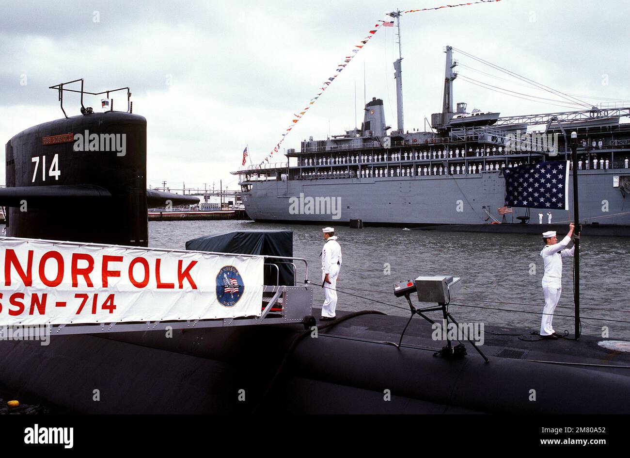 A sailor raises the union jack on the deck of the nuclear-powered ...