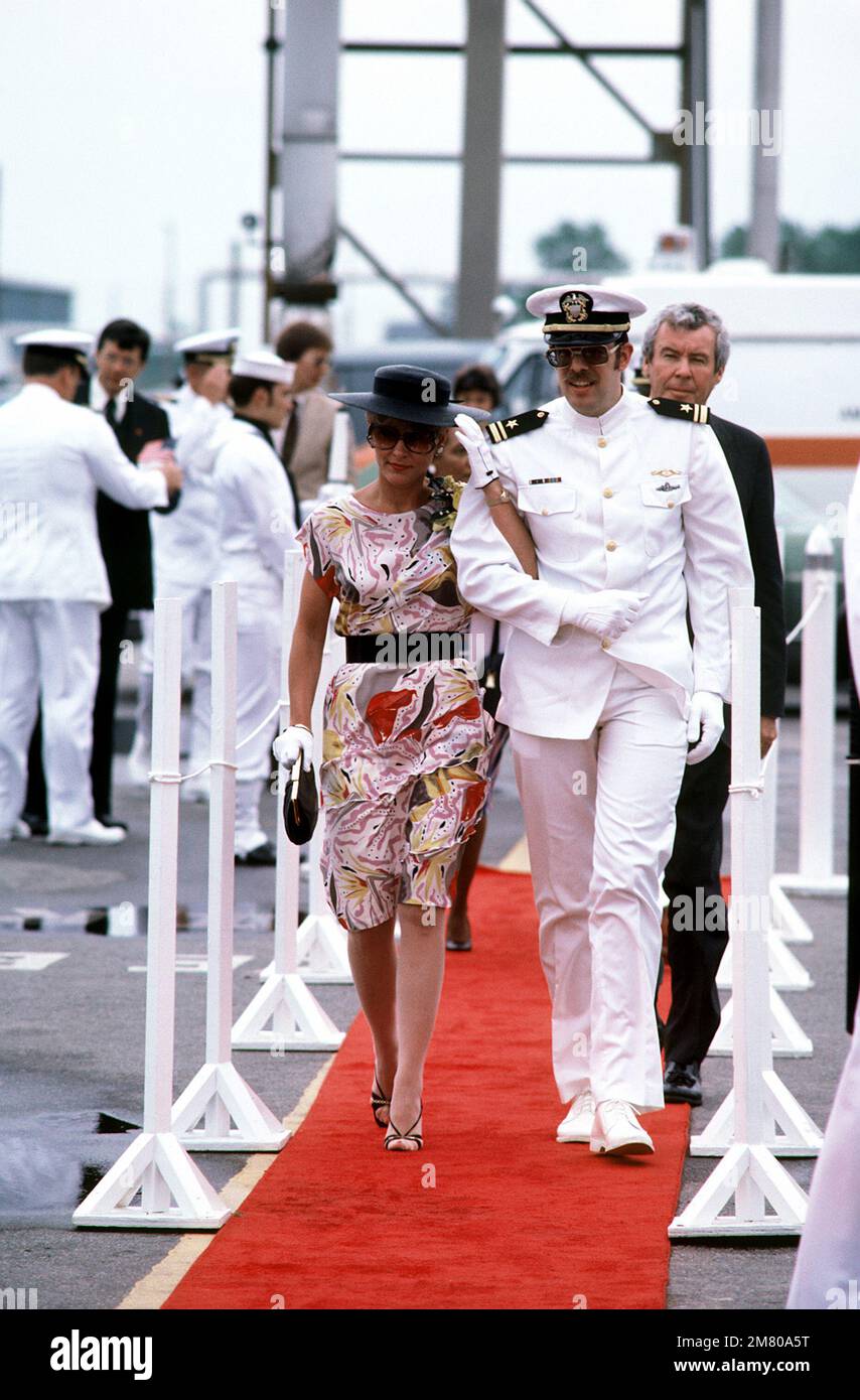 An honored guest is escorted to her seat by an officer at the beginning ...
