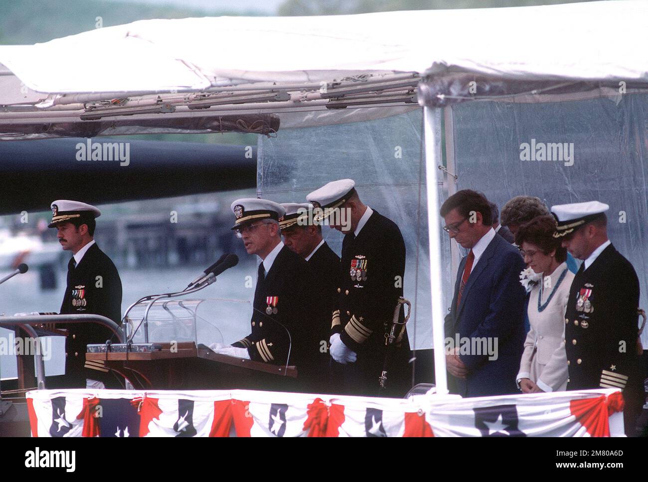 A chaplain gives the invocation during the commissioning ceremony for ...