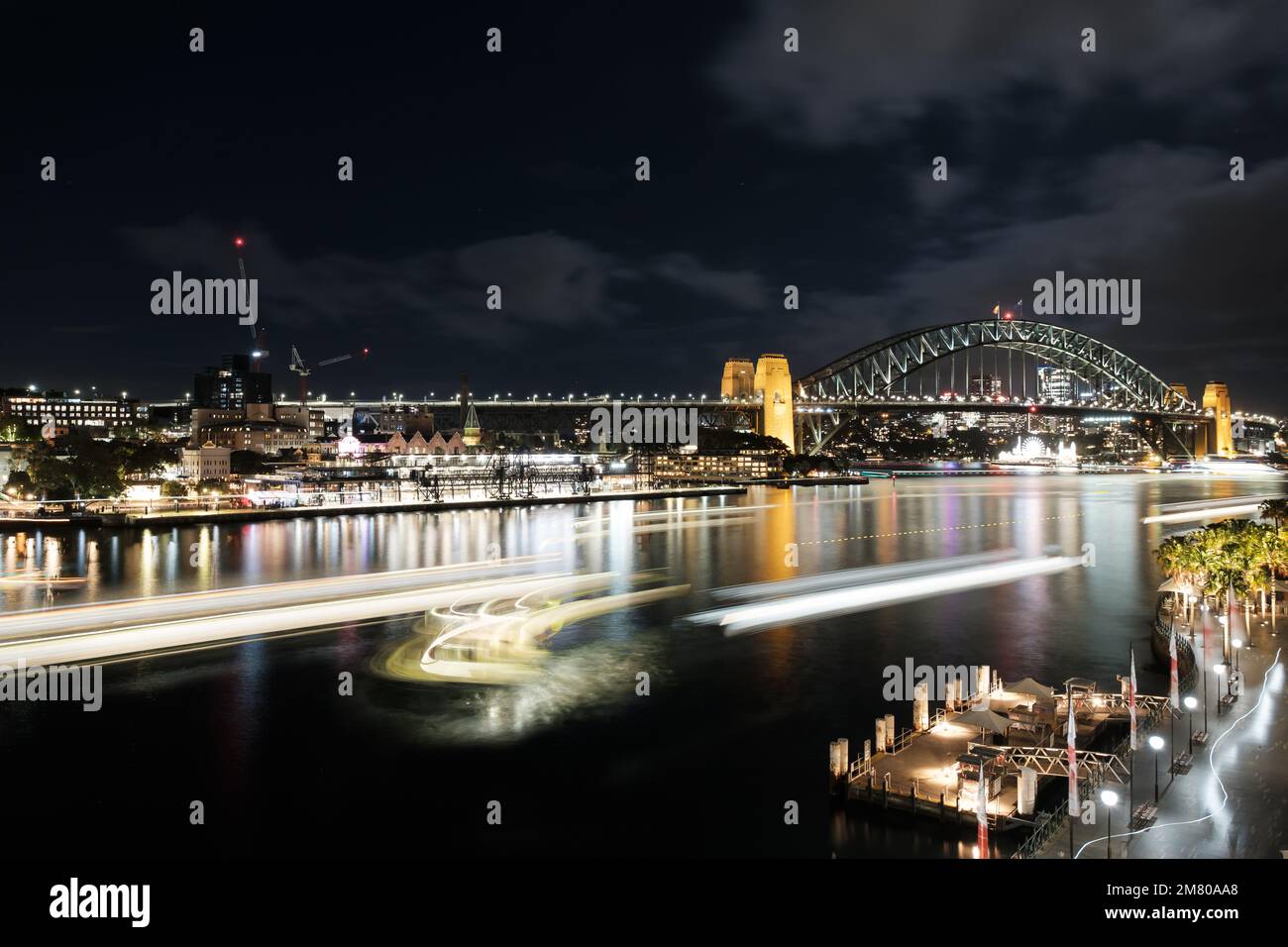 Light trails at night of ferries arriving and departing from Circular ...