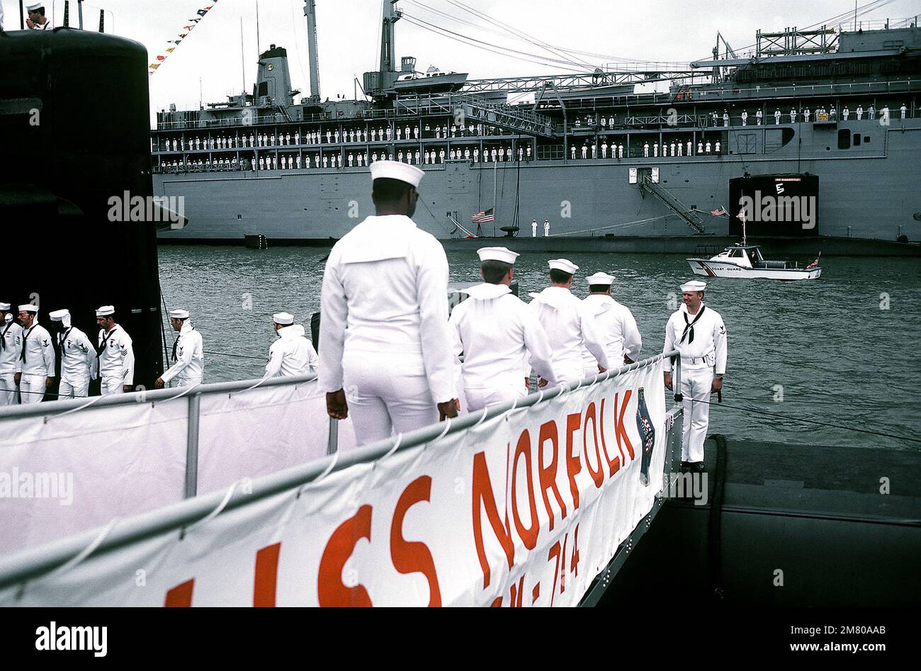 Crew members go aboard the nuclear-powered attack submarine USS NORFOLK ...