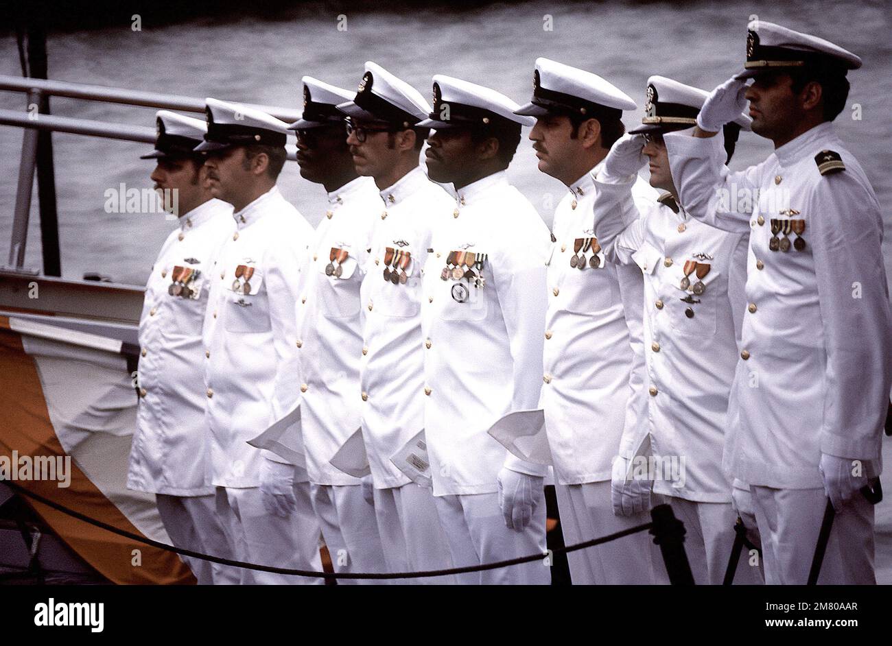 Crewmen and officers stand at attention on the deck of the nuclear ...